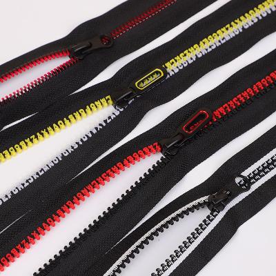China Hard Thick Precision #5 Resin Zipper Gold Tooth Zipper For Fire Resistant Jackets for sale