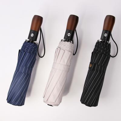 China 23 Inch 3 Fold Auto Open Close Umbrella with Wooden Handle 105cm Canopy for sale
