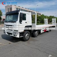 China Sinotruk HOWO 8x4 400HP Flatbed Truck with 9m Manganese Steel Deck and Hydraulic Ramp for Heavy Machinery Transport for sale