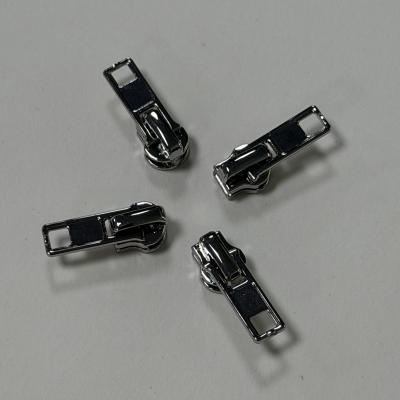 China Auto Lock Metal Zipper Slider #3 Anti Slip Self Locking for Bags Workwear for sale