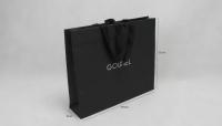 China Full Embossing Black Dyed Garment Paper Shopping Bags With Handles for sale