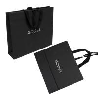 China Full Embossing Black Dyed Garment Paper Shopping Bags With Handles for sale