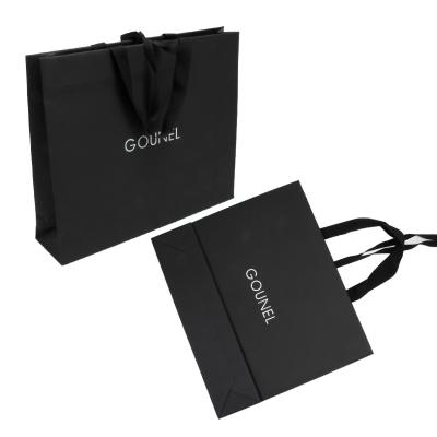 China Full Embossing Black Dyed Garment Paper Shopping Bags With Handles for sale