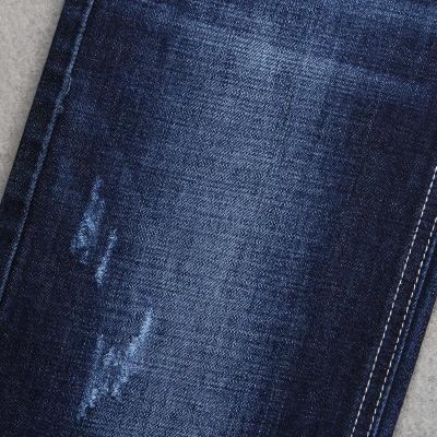 China Soft 9.5oz 100% cotton denim fabric desizing cross hatch slub jeans fabric for men wear for sale