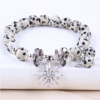 China Custom 8mm Round Dalmatian Jasper Bead Bracelet with Snowflake Charm Copper Silver Plating for sale