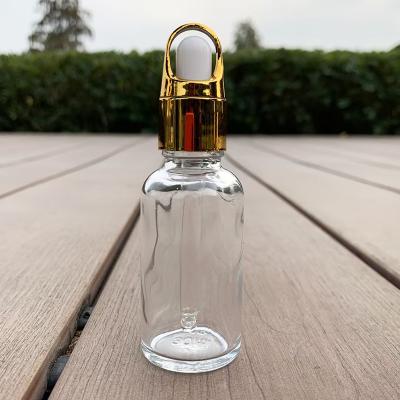 China Clear Glass Dropper Bottle with Gold Cap for sale