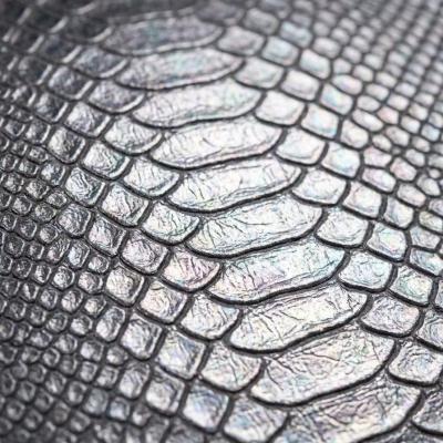 China Hot Sale Premium 0.9mm Stretch 3D Embossed Foil Printed Pearlescent Supple PU Synthetic Leather for Handbags & Luggage for sale