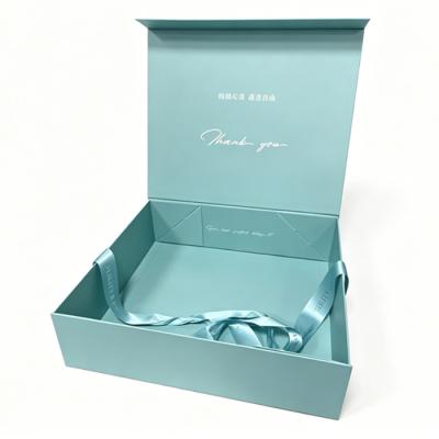 China Collapsible Gift Boxes with Ribbon Closure Spot UV Finish Cosmetic Beauty Packaging for sale