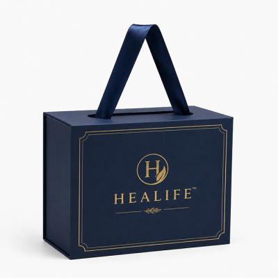 China Rigid Custom Gift Boxes with Ribbon Handle Gold Foil Stamping Brand Presentation Packaging for sale