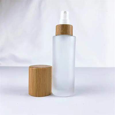 China Glass Shampoo Cosmetic spray Pump Bottle With Bamboo Cap for sale