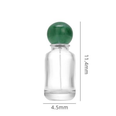 China Luxury Round Glass Perfume Bottle 50ml with Marble Lid and Mountain Bottom Design for sale