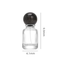 China Luxury Round Glass Perfume Bottle 50ml with Marble Lid and Mountain Bottom Design for sale
