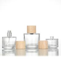 China Round Frosted Clear Glass Perfume Bottle 30ml 50ml 100ml with Wooden Cap for sale