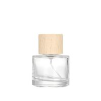 China Round Frosted Clear Glass Perfume Bottle 30ml 50ml 100ml with Wooden Cap for sale