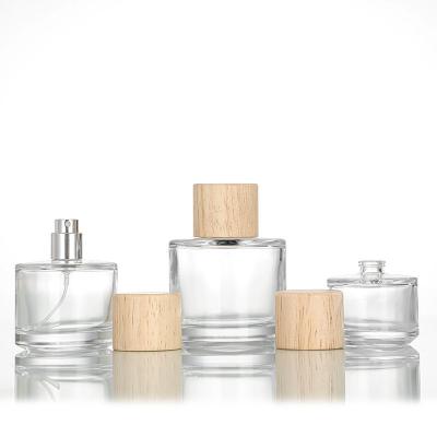 China Round Clear Transparent Glass Perfume Bottle with Wooden Cap Custom Luxury 100ml Packaging Box for sale