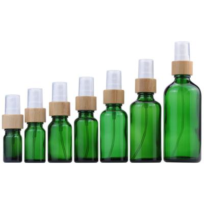 China 30ml Vintage Colored Glass Bottle with Bamboo Pump Sprayer 28/415 for Skin Care for sale