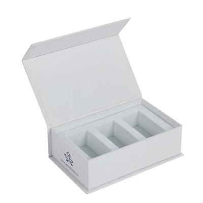 China Luxury White Magnetic Rigid Cardboard Cosmetic Bottle Essential Oil Packaging Boxes with Foam Insert for sale
