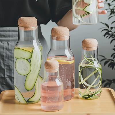 China Heat Resistant Borosilicate Glass Drinking Water Bottle With Screw Cap For Beverage for sale