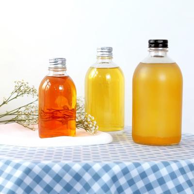 China Crystal Clear Glass Beverage Bottle With Screw Cap 150ml 250ml 350ml 500ml for sale