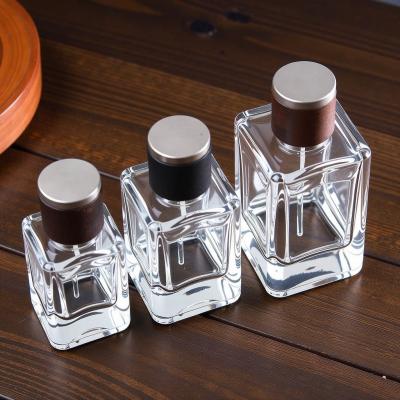 China Portable Square Perfume Glass Bottle 15ml 30ml 50ml 100ml With Heavy Bottom Sprayer Round Lid for sale