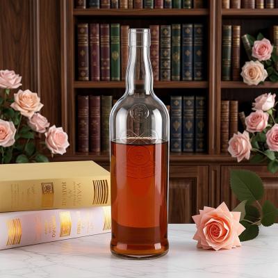 China 750ml Luxury Embossed Logo Glass Liquor Bottle With High Flint Transparency For Whiskey Spirits for sale