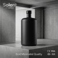 China Matte Black Cylindrical Glass Bottle With Leakproof Seal For Liquor Spirits for sale