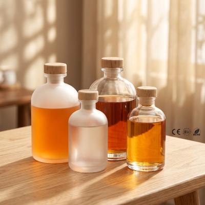 China 250ml 500ml Round Shoulder Glass Liquor Bottle With Heavy Base For Spirits Cold Brew Beverage for sale