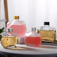 China 100ml 250ml Glass Bottle Cat Ear Leakproof Custom Logo For Beverage Liquor Packaging for sale