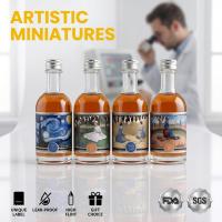 China 50ml Mini Glass Liquor Bottle With Artistic Painting Label Leak Proof Screw Cap For Spirits for sale