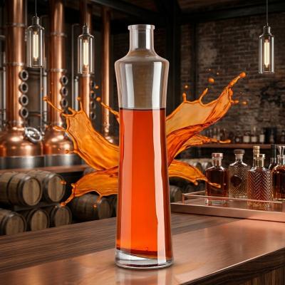 China Slanted Base Glass Liquor Bottle With High Flint Transparency Asymmetrical Molding For Spirits for sale