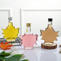 China Maple Leaf Shape Glass Bottle For Liquor With Customized Printing Spirit Packaging for sale
