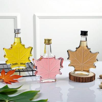 China Maple Leaf Shape Glass Bottle For Liquor With Customized Printing Spirit Packaging for sale