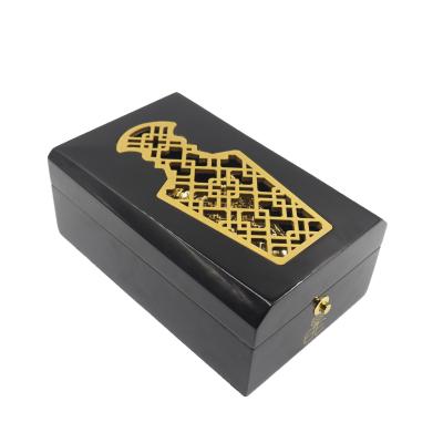 China Luxury Black Perfume Box with Gold Stamping Hollow Carving Sliding Packaging 120ml for sale