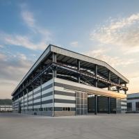 China Q235B Steel Structure Warehouse Featuring Sliding Door Suitable for Gymnasium Buildings Durable and Easy to Assemble for sale