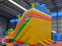 China Outdoor Park Game 2-Lane Tropical Palm Tree PVC Inflatable Dinosaur Jump Bounce Slide for sale