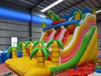 China Outdoor Park Game 2-Lane Tropical Palm Tree PVC Inflatable Dinosaur Jump Bounce Slide for sale