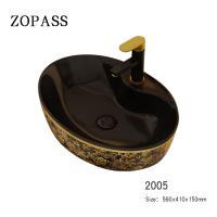 China Luxury Oval Freestanding Vanity Basin Black Gold Ceramic 560x410mm with Faucet for sale