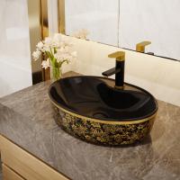China Luxury Oval Freestanding Vanity Basin Black Gold Ceramic 560x410mm with Faucet for sale