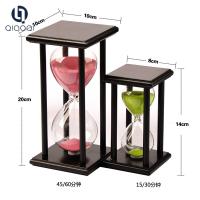 China Beautiful home and office decoration colorful hourglass with wooden frame for sale