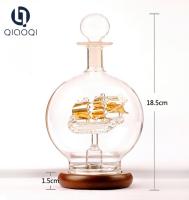China Creative transparent glass sailing with wood base ship in bottle for sale