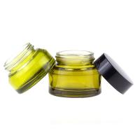 China IS09001 Glass Face Cream Jars Clear Olive Green Glass Cylinder Jars With Lids for sale