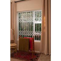 China Durable Aluminum Concertina Grille Sliding Window with Burglar Bars Custom Size for sale
