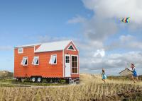 China AS/US Prefabricated Tiny House Hotel Unit Orange Black Mobile House On Wheels For Travel for sale