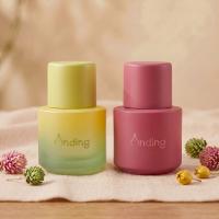 China Glass Perfume Bottles 50ml Cylinder Empty Plastic Cap Printing Luxury Design for sale