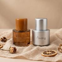 China Glass Perfume Bottles 50ml Cylinder Empty Plastic Cap Printing Luxury Design for sale