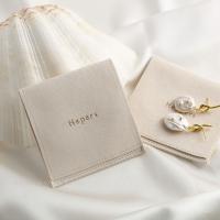 China custom embossed suede microfiber jewelry pouch with insert card pads custom logo for sale