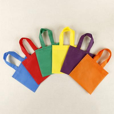 China Reusable Non-Woven Favor Bags 9.5x9.5 Inch Pinata Goodie Gift Bag Colorful Tote Candy Bags for Birthday Party for sale