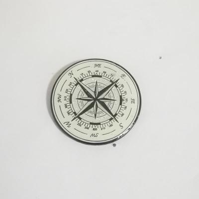 China Custom Iron Stamped Round Lapel Pins 1.25 Inch Compass Design Black Nickel Epoxy Coated for sale