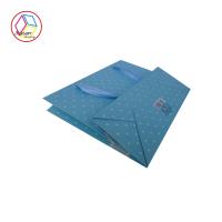 China Personalised Shopping Bags Blue Color Coated Paper Twisted Handle for sale