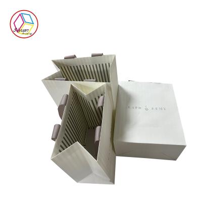 China Custom Eco Friendly Silver Foil Logo Handmade Paper Bags with Ribbon 310x435x280mm for sale